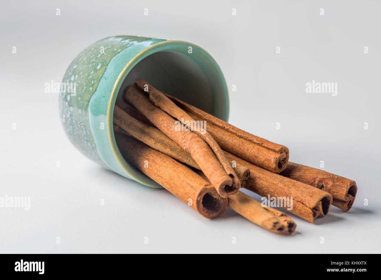 Cinnamon sticks spilling from bowl Stock Photo - Alamy