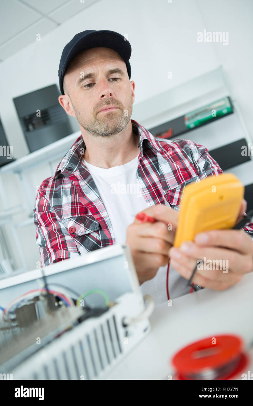 Electrician using multimeter Stock Photo - Alamy