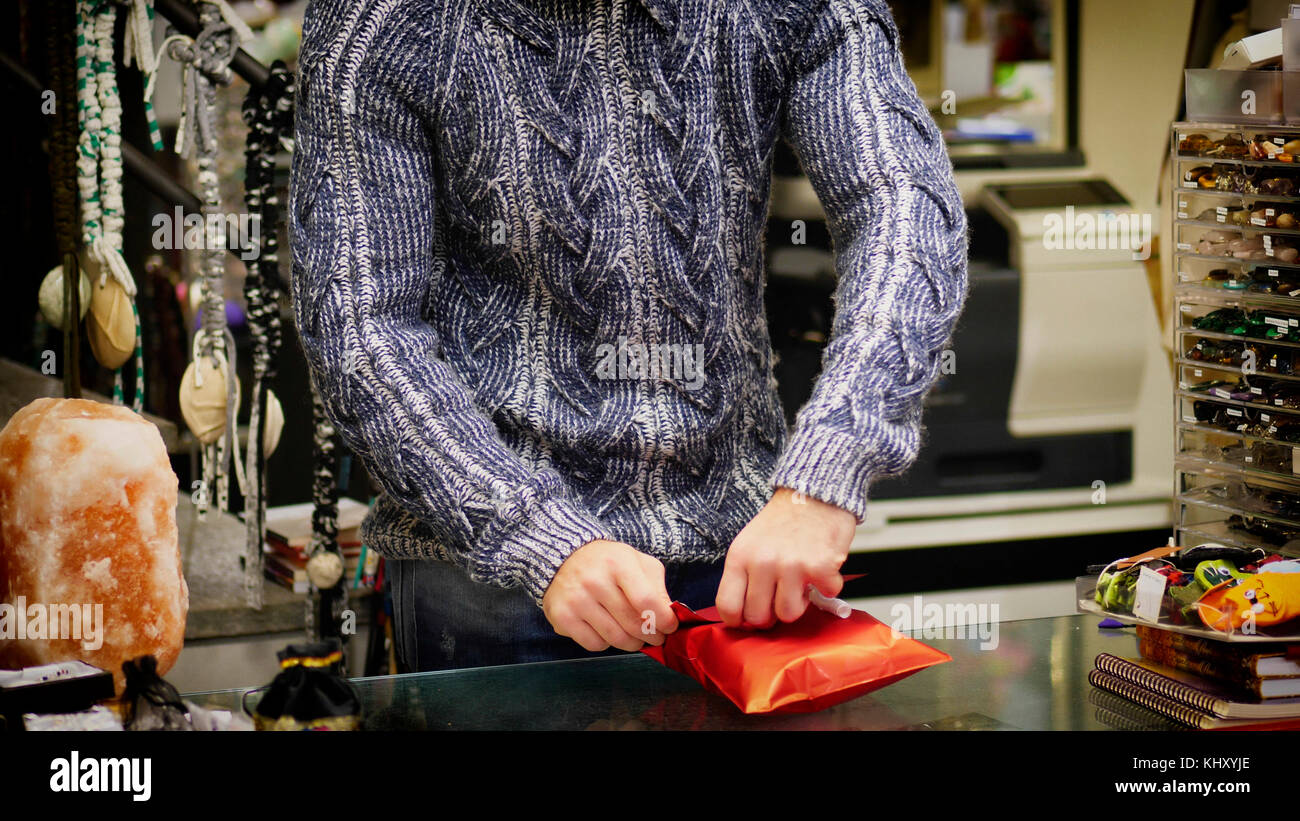 Crop shot of man wrapping purchase while working in shop of gifts Stock ...