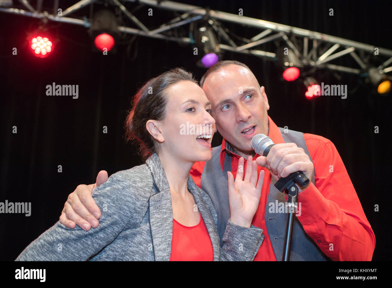 Couple singing on stage Stock Photo - Alamy