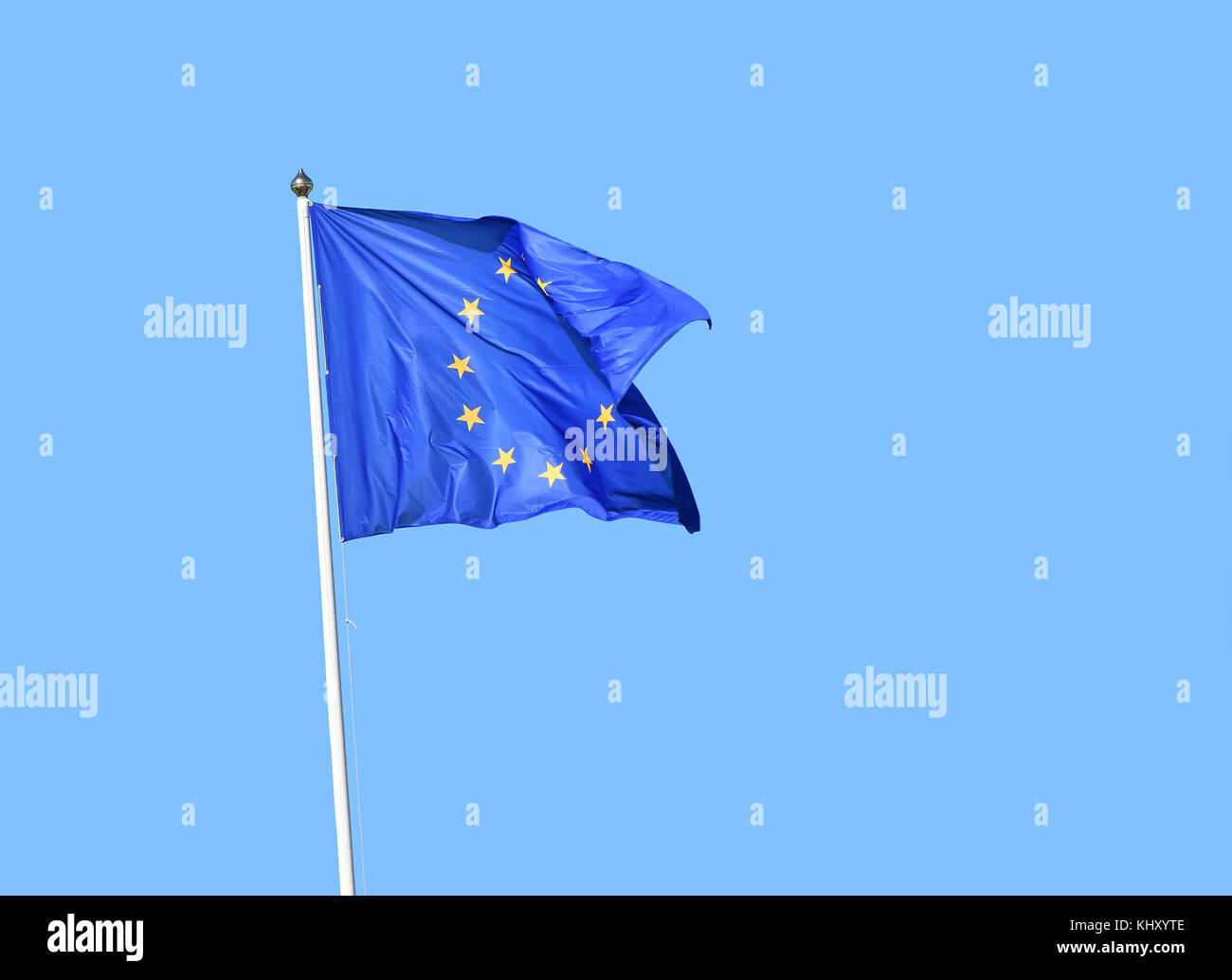 European Union EU flag flying in the wind over clear blue sky, side ...