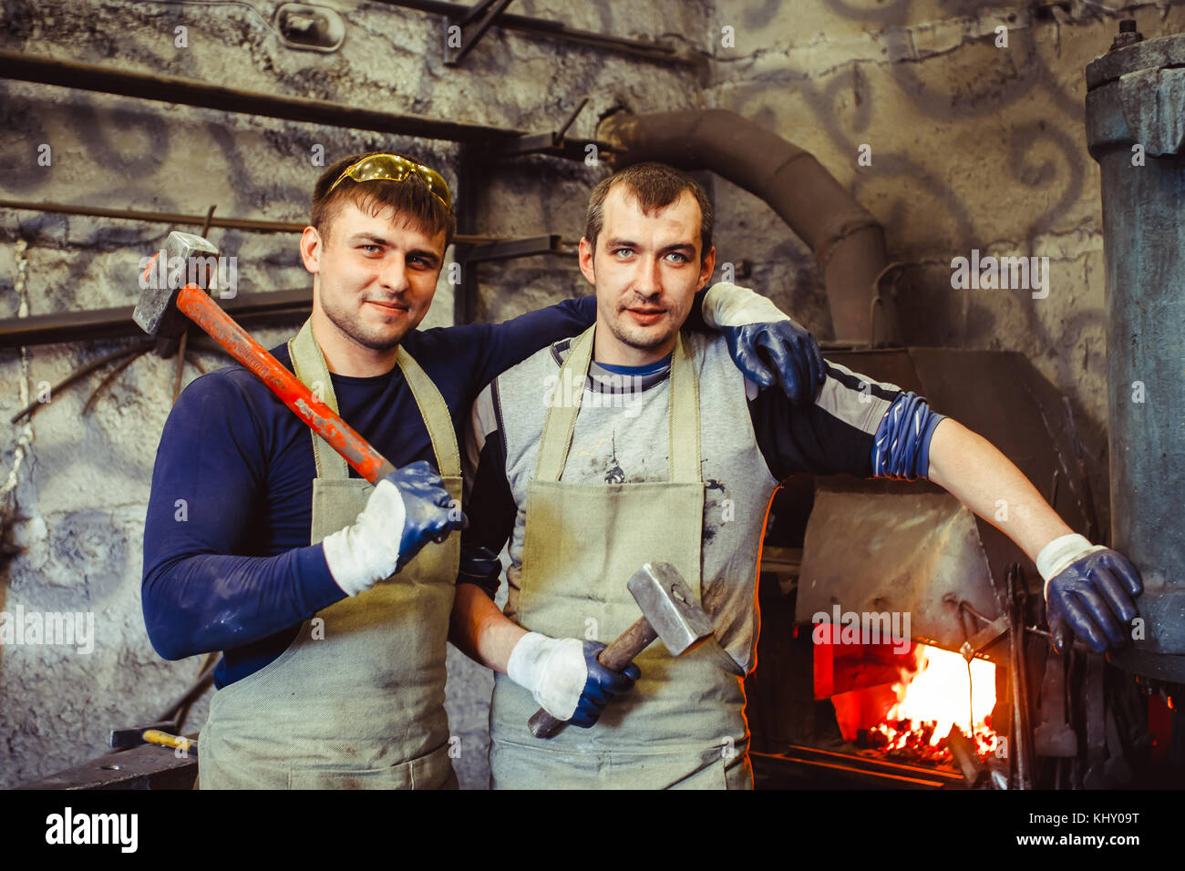 two forge are in working clothes in the forge Stock Photo - Alamy