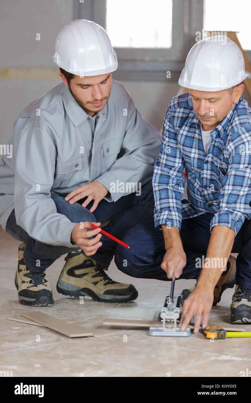 tile cutting worker working with floor tile cutting Stock Photo - Alamy