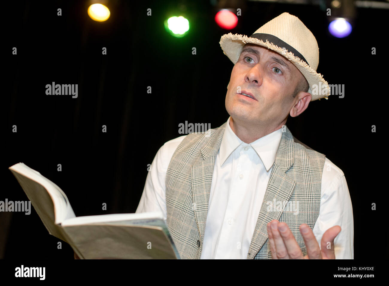 Man reading poetry on stage Stock Photo - Alamy