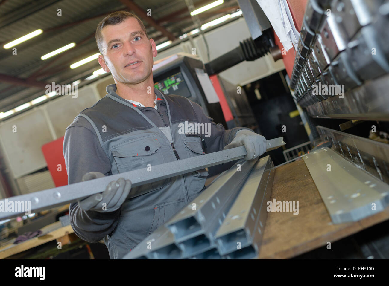 man working with metal bars in factory Stock Photo - Alamy