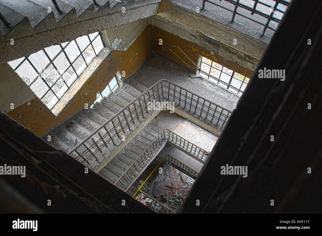 Abandoned and destroyed stairs in old factory. Forgotten staircase with ...
