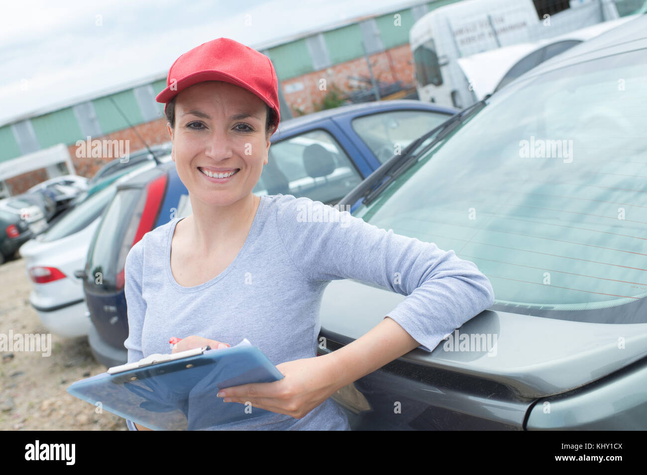 beautiful scrap yard manager posing with clipboard and smiling Stock ...
