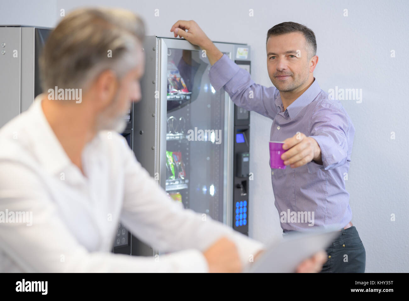 business colleague having coffee break in the office Stock Photo - Alamy