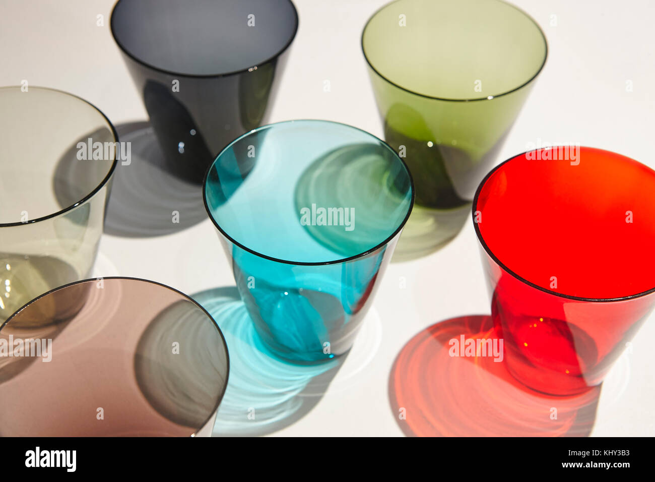 Vibrant colored crystal glasses on a white background. Crockery ...