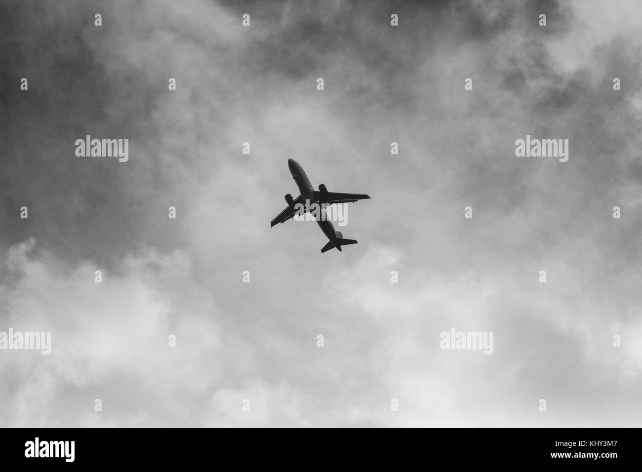Airplane flying in dark clouds hi-res stock photography and images - Alamy
