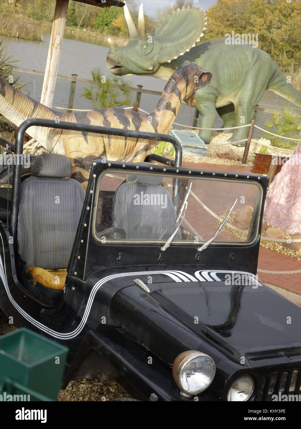 A velociraptor stalking a triceratops dinosaur park Stock Photo - Alamy