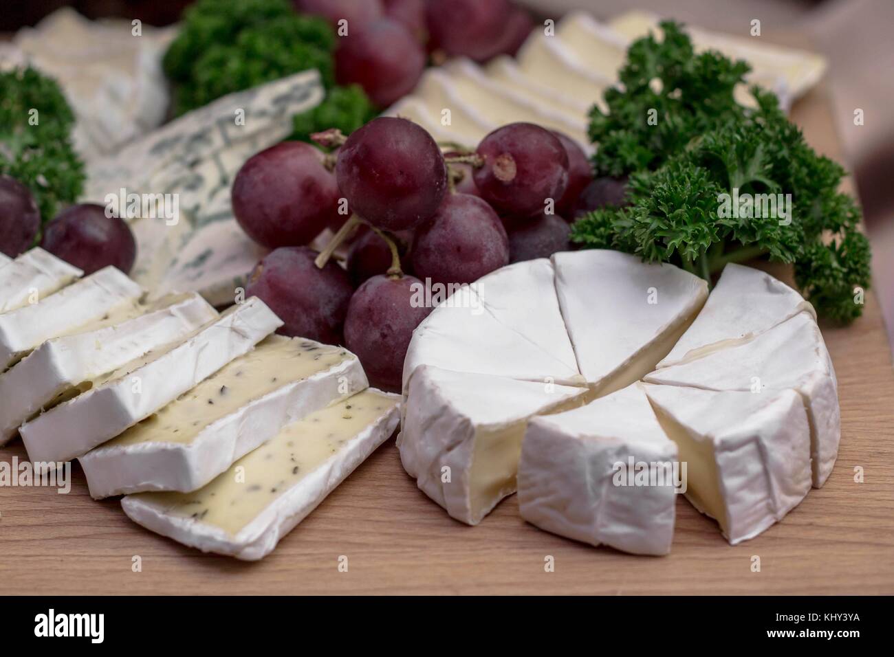 Cheese board: Camembert with herbs decorated with grapes and parsley ...
