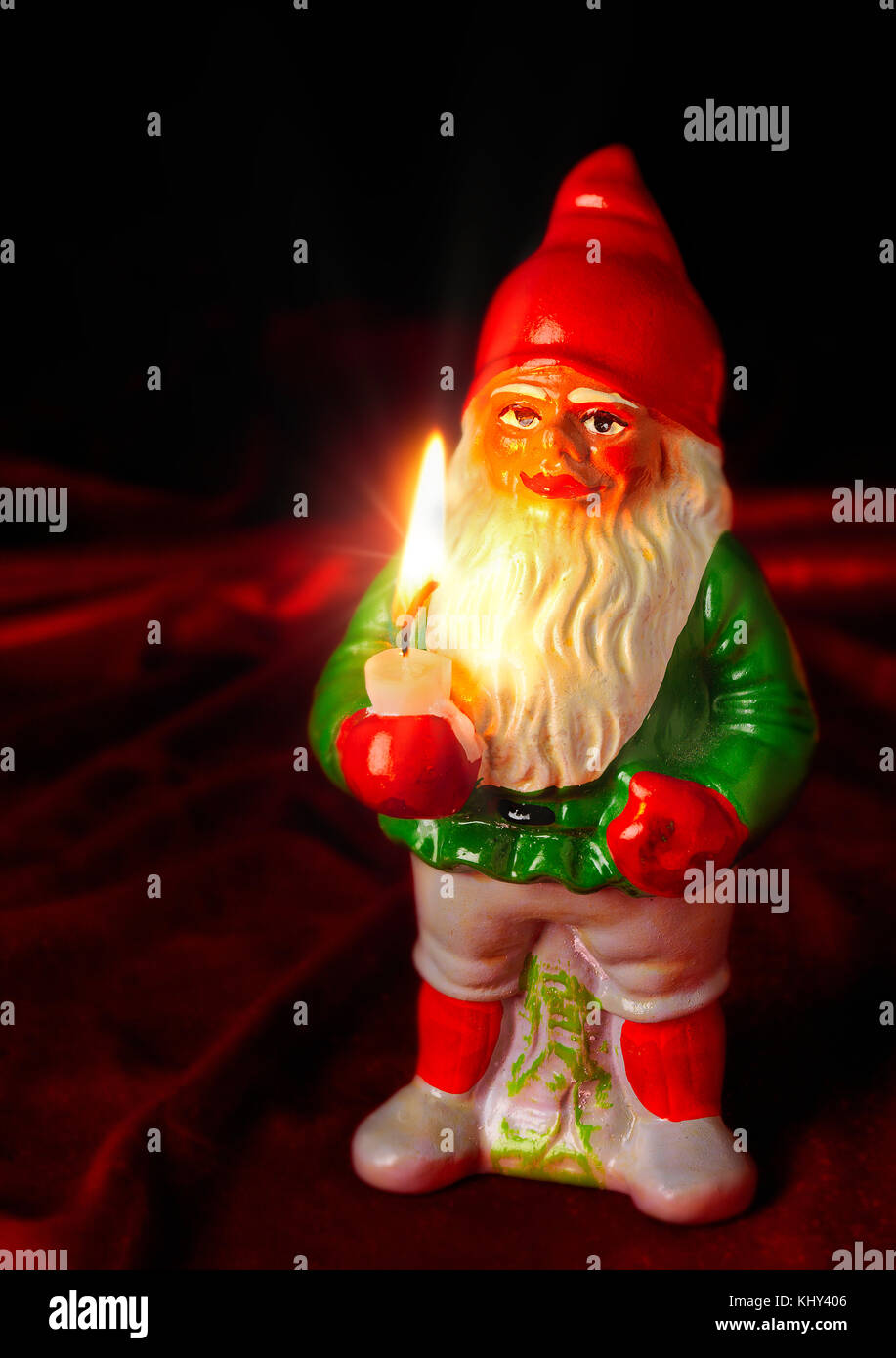 Porcelain Santa Claus with a burning candle Stock Photo - Alamy