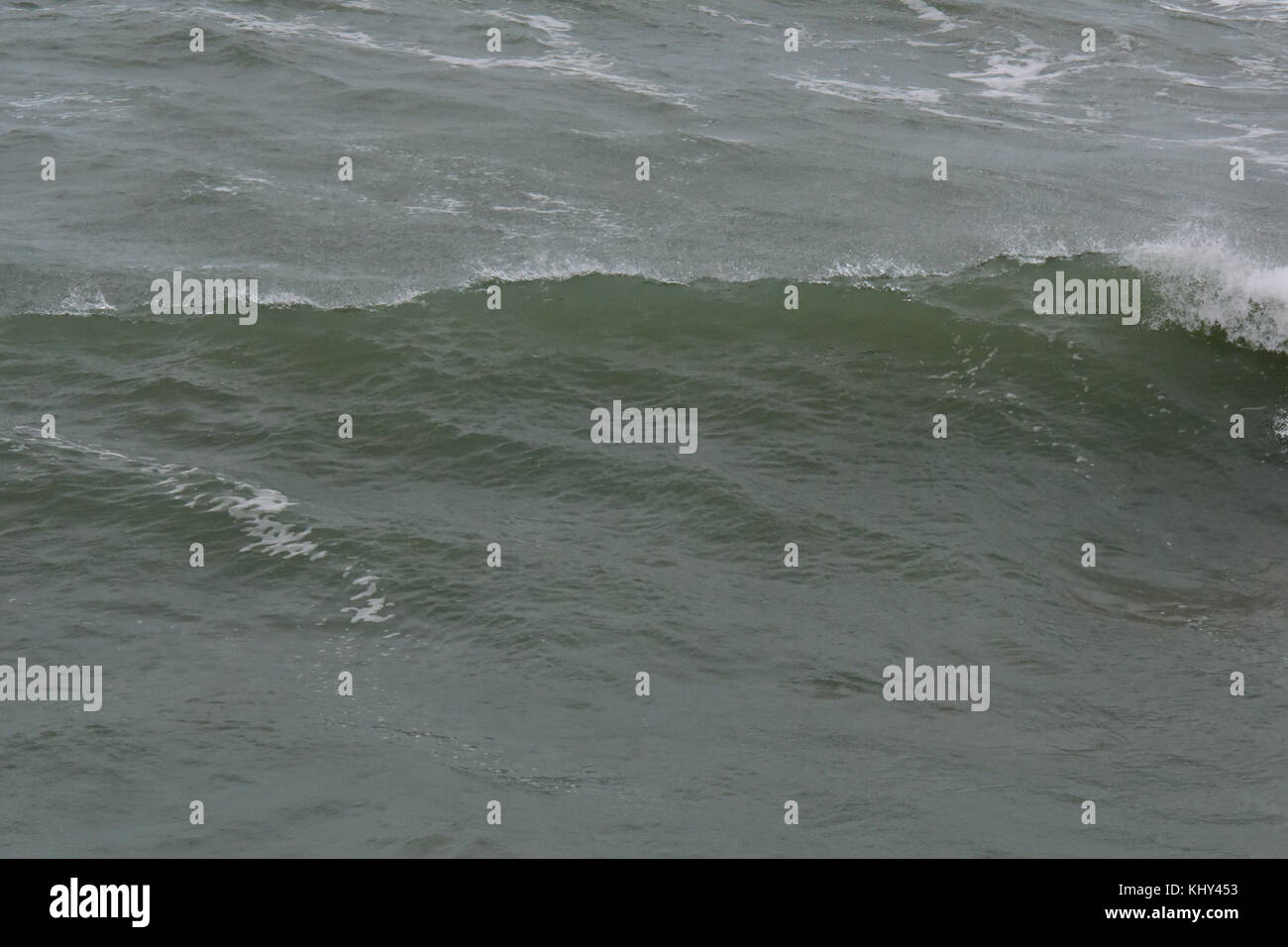 A choppy and cold looking sea in stormy rough weather with white crests ...