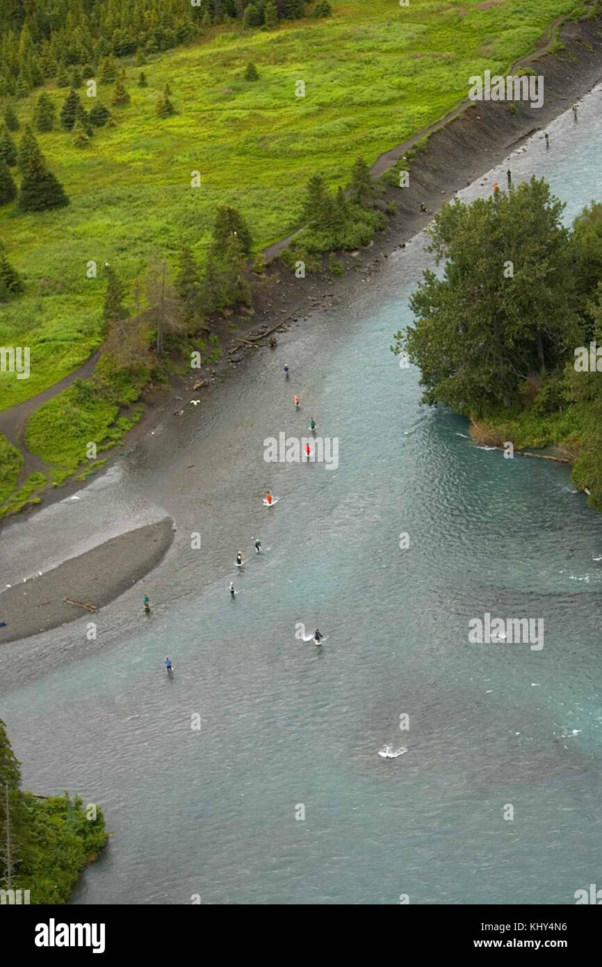 Combat fishing along stream Stock Photo - Alamy