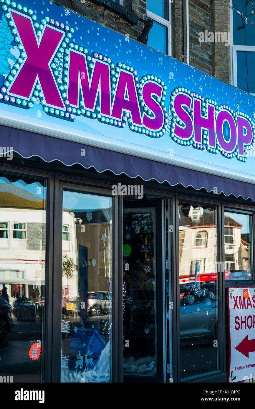 A colourful sign above a Xmas Christmas shop Stock Photo - Alamy