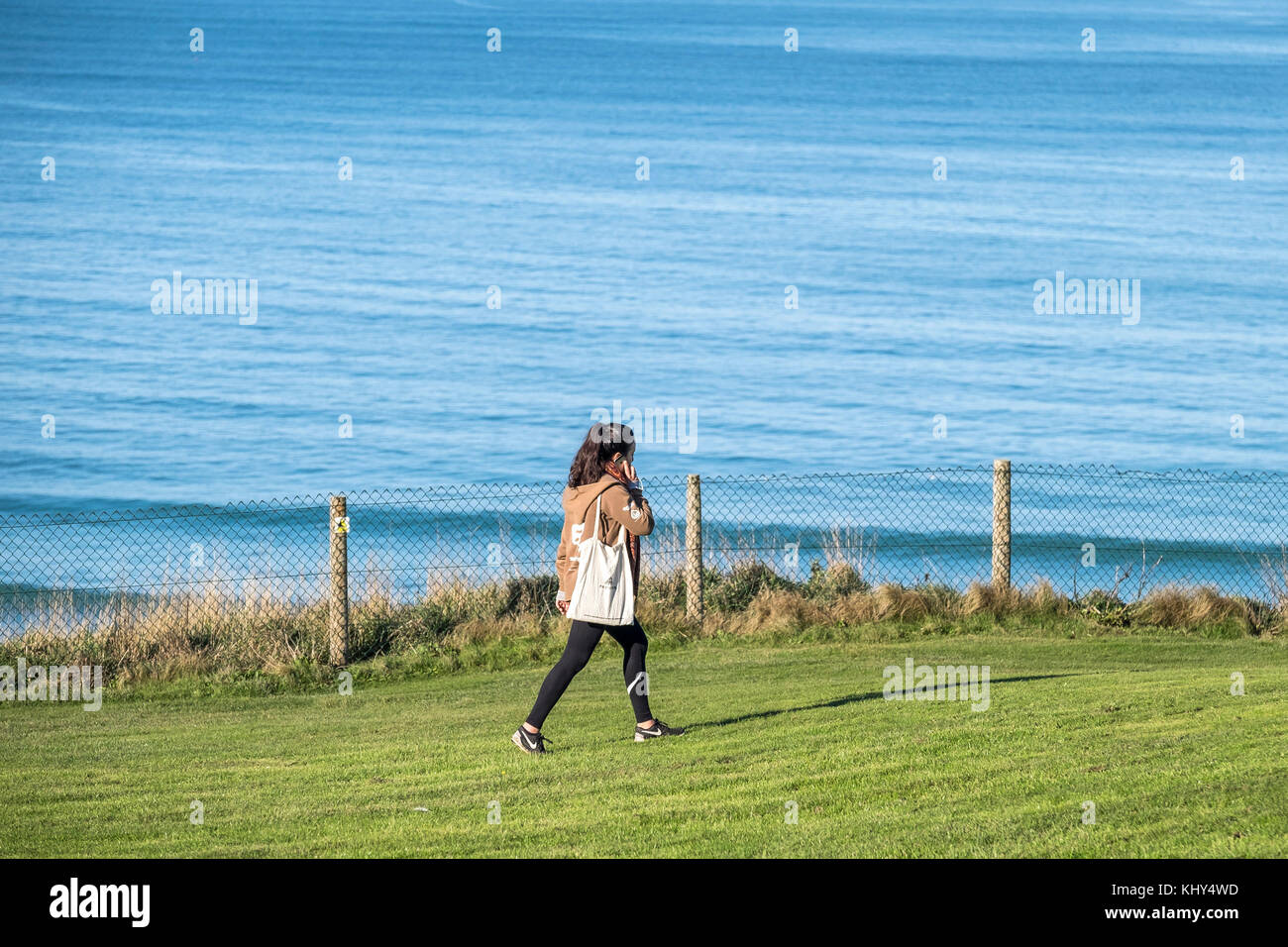 Woman walking along cliff hi-res stock photography and images - Alamy