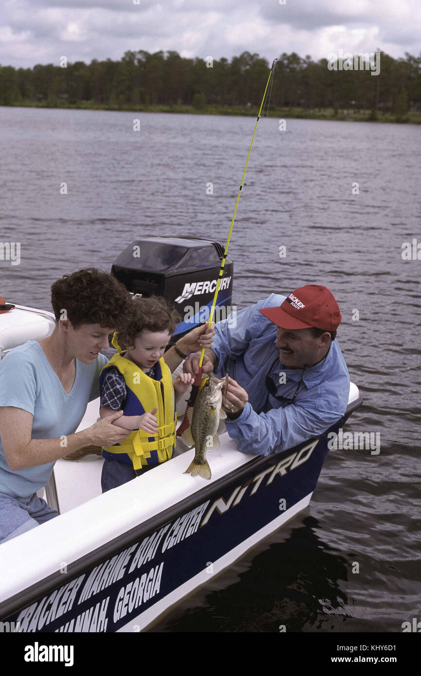 Daughter with her father and mother catches fish from a boat Stock ...