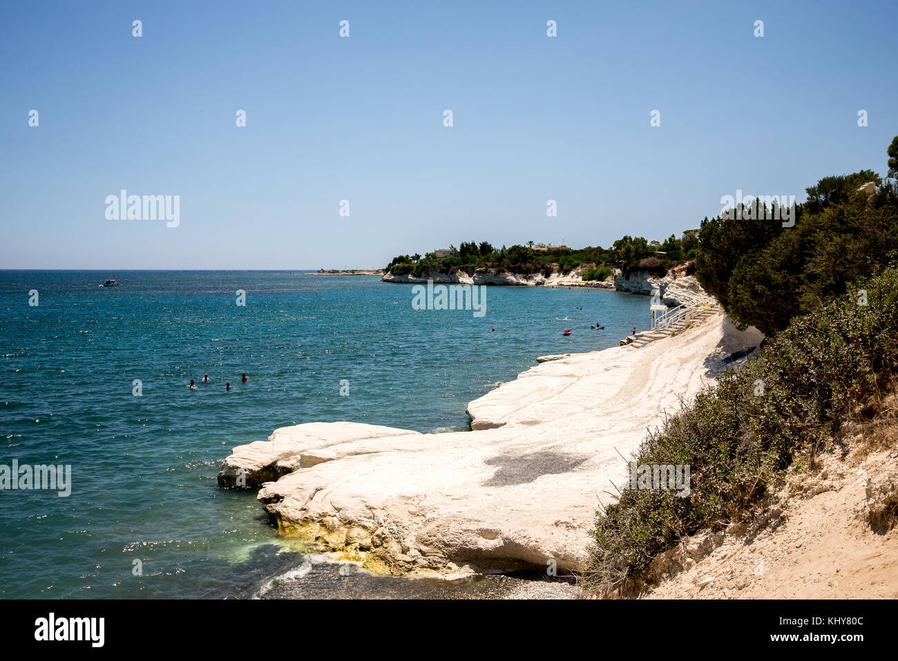 Scenic Governor's white limestone beach with tourists swimming, between ...