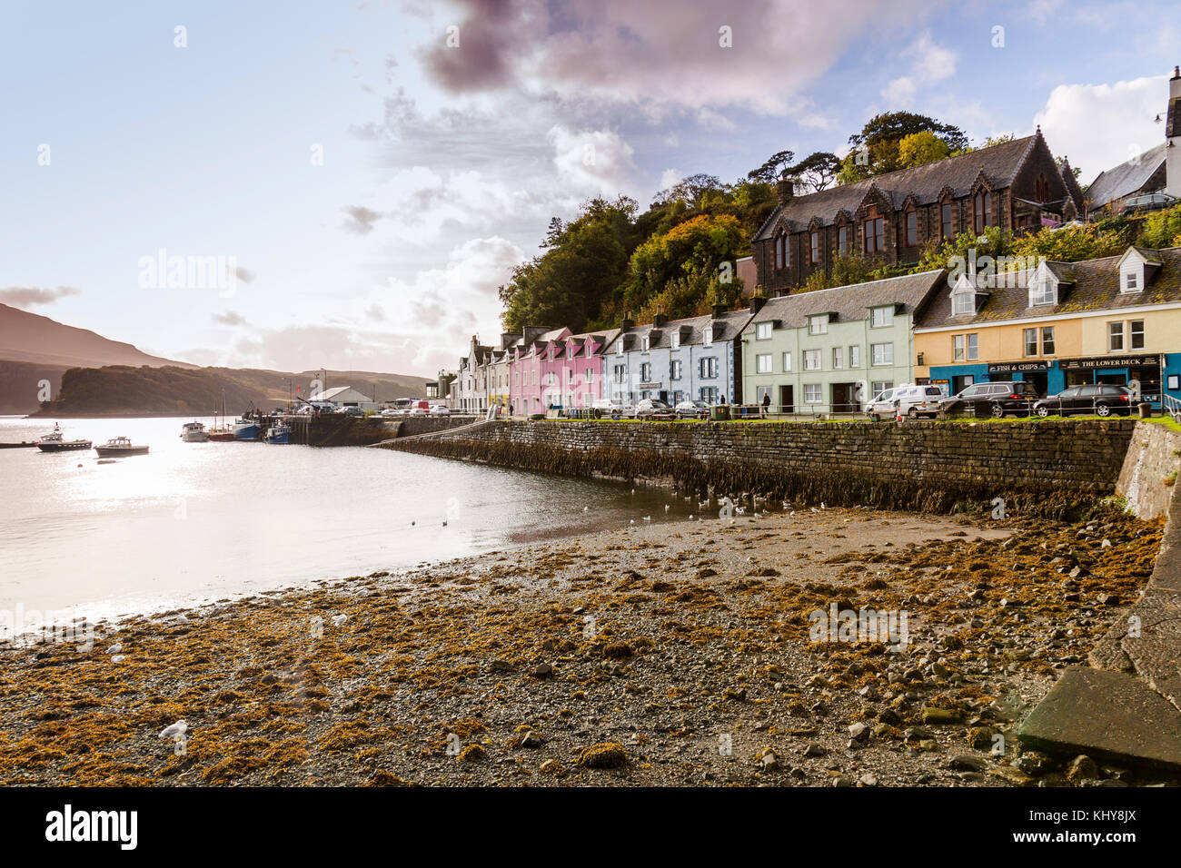 Rows of colourful houses overlook the harbour in Portree, the main town ...