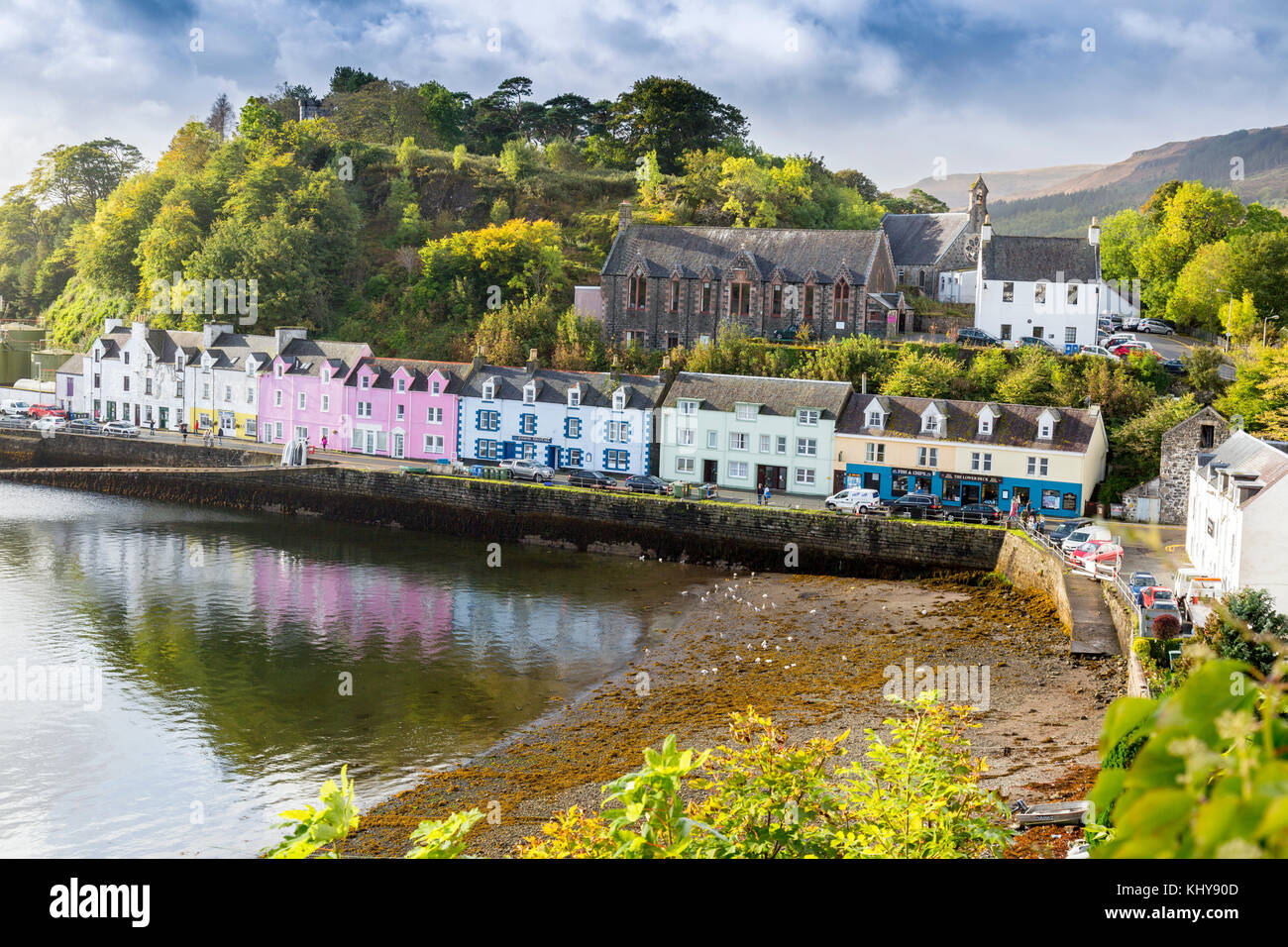 Rows of colourful houses overlook the harbour in Portree, the main town ...