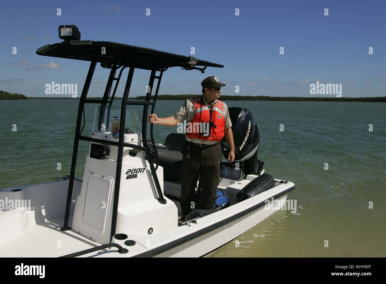 An image of an employee standing in a service boat, possibly part of a ...