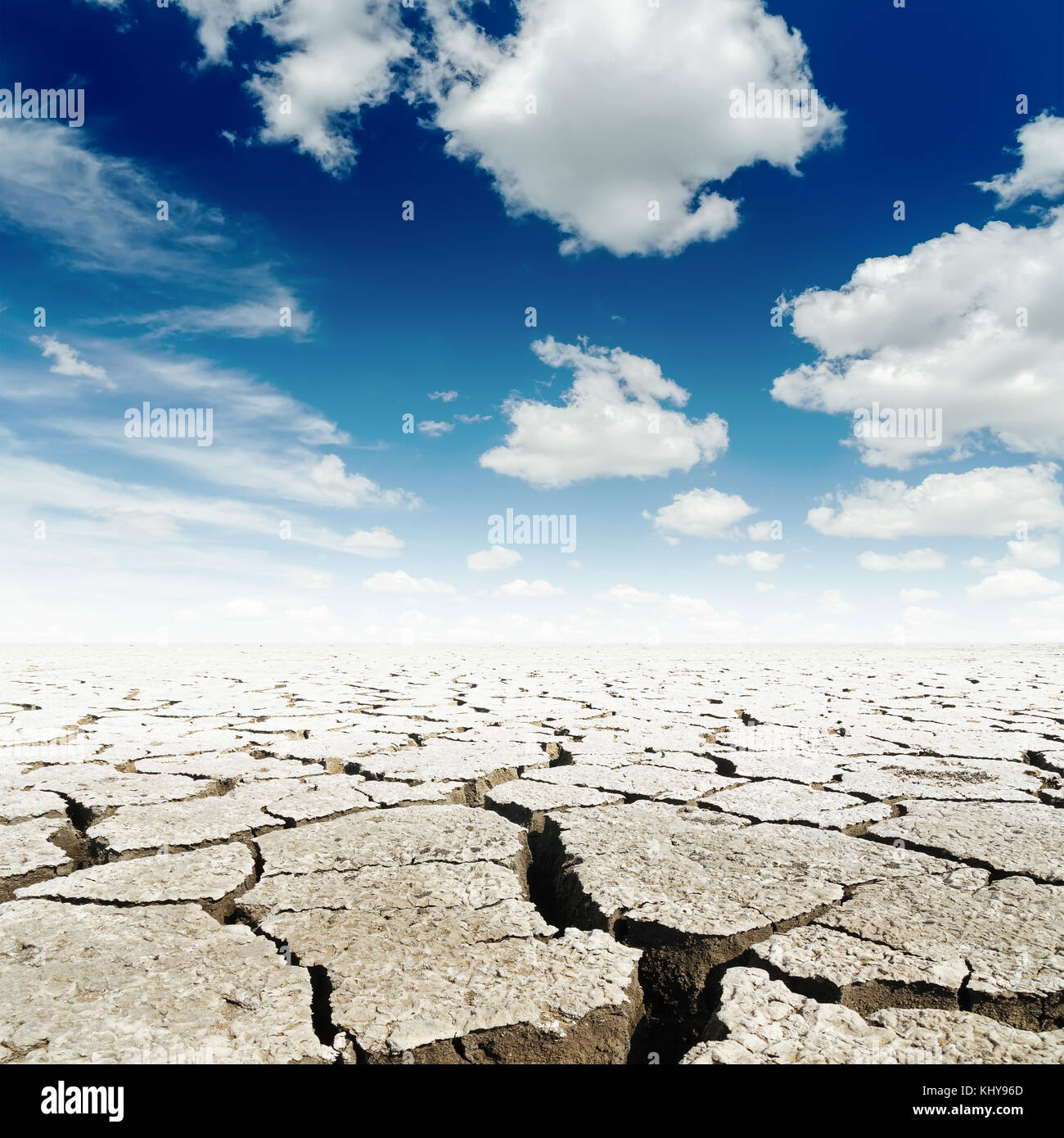 deep blue sky with clouds over drought earth with cracks Stock Photo ...