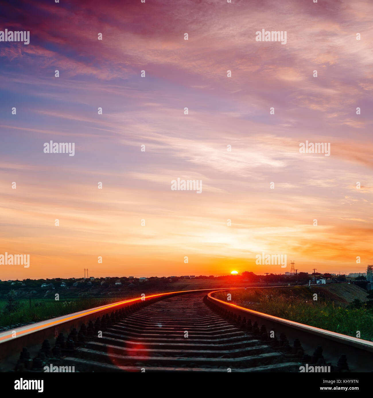 purple colored sunset over railroad Stock Photo - Alamy