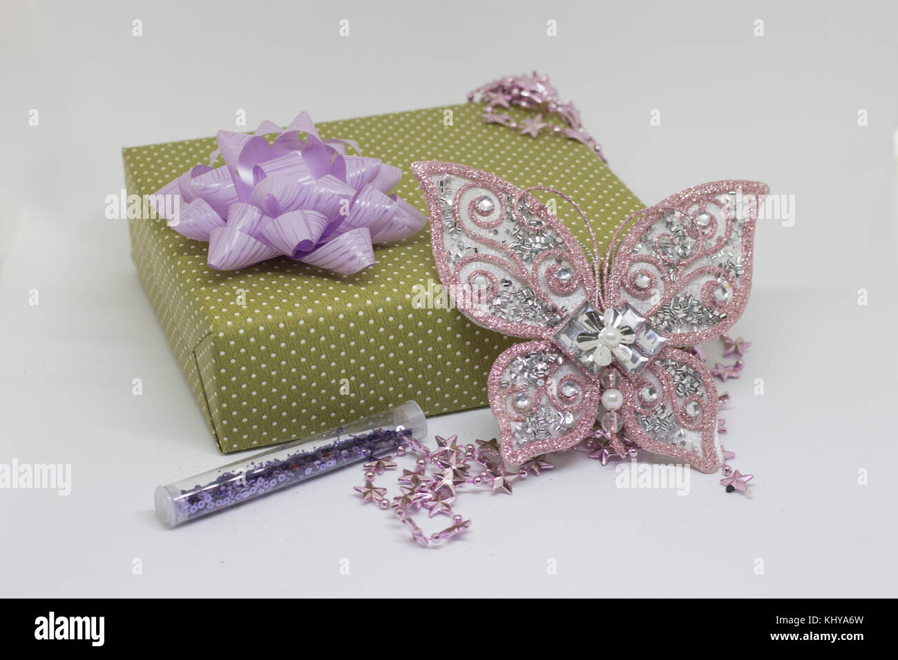 Gift box and lilac decorative butterfly on a light background Stock ...