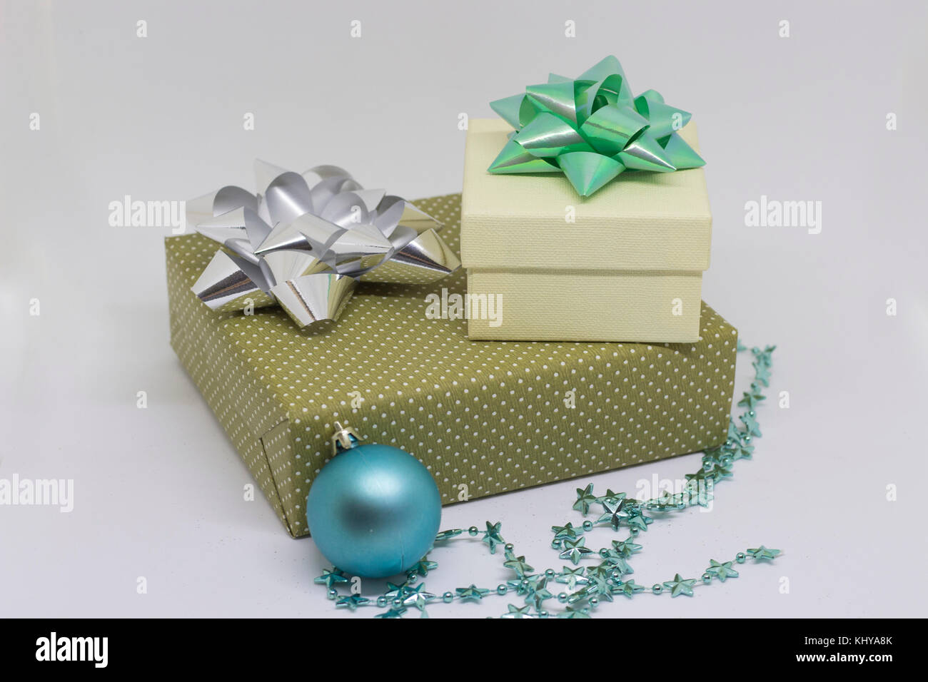 Two gift boxes and a ball on a fresh background Stock Photo - Alamy