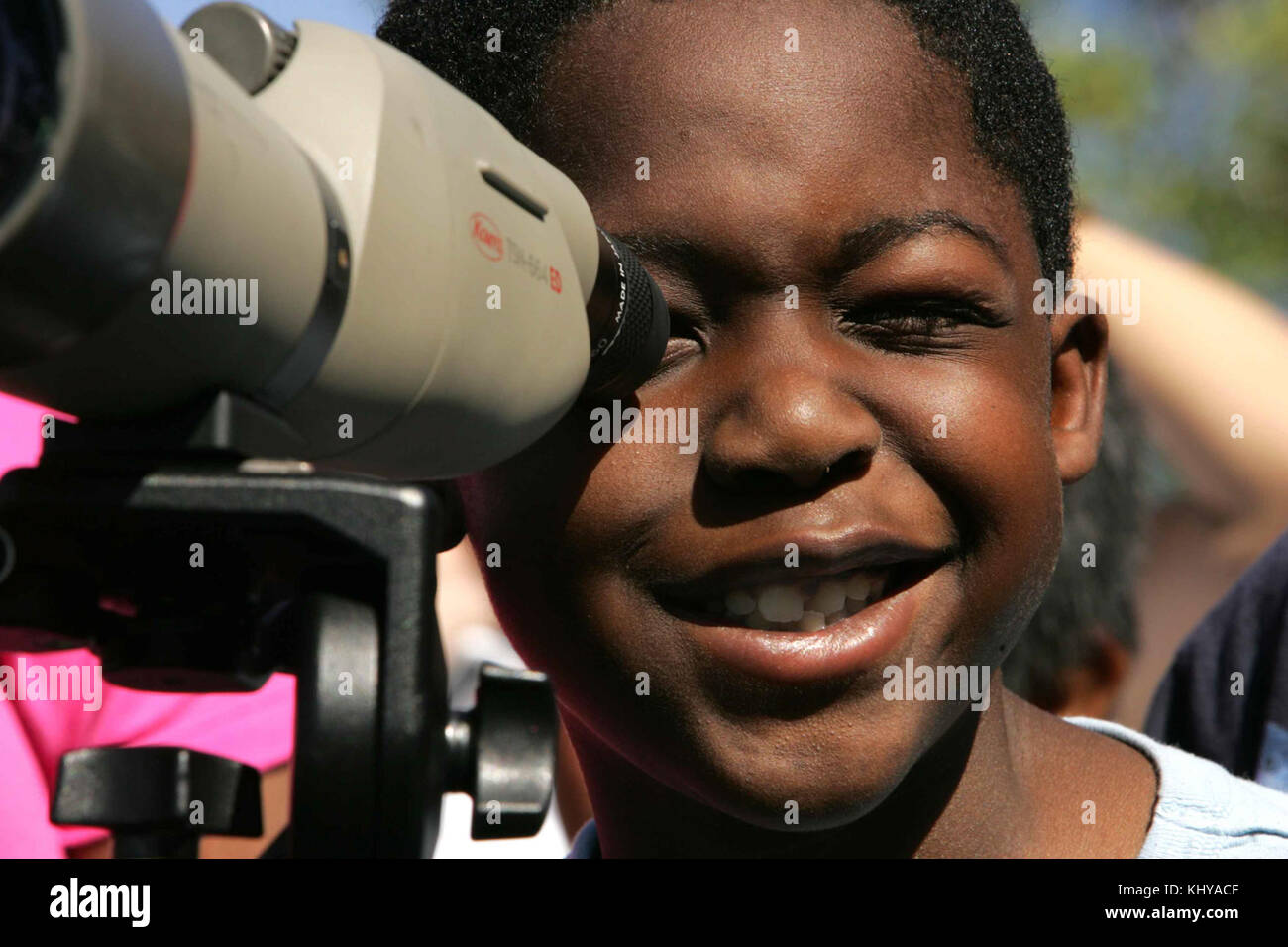 Afro American boy face child enjoys the view through the lens of a ...
