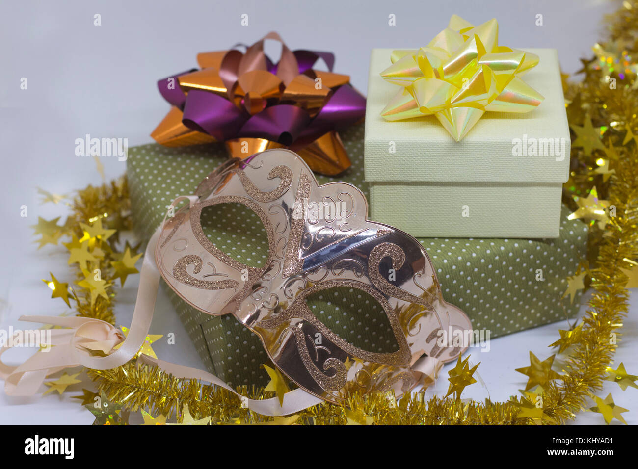 Two gift boxes and carnival mask on white background Stock Photo - Alamy