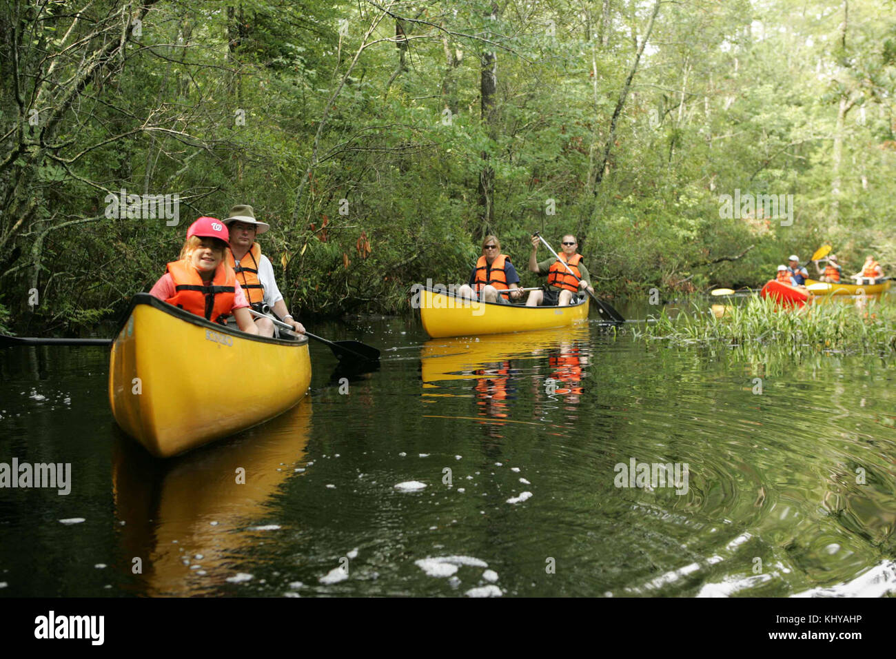 Families floating down the river in boats Stock Photo - Alamy