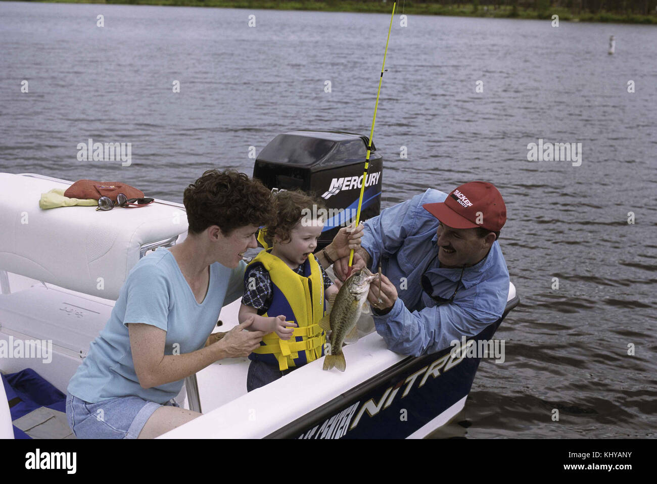 Family recreational boating and fishing on lake Stock Photo - Alamy
