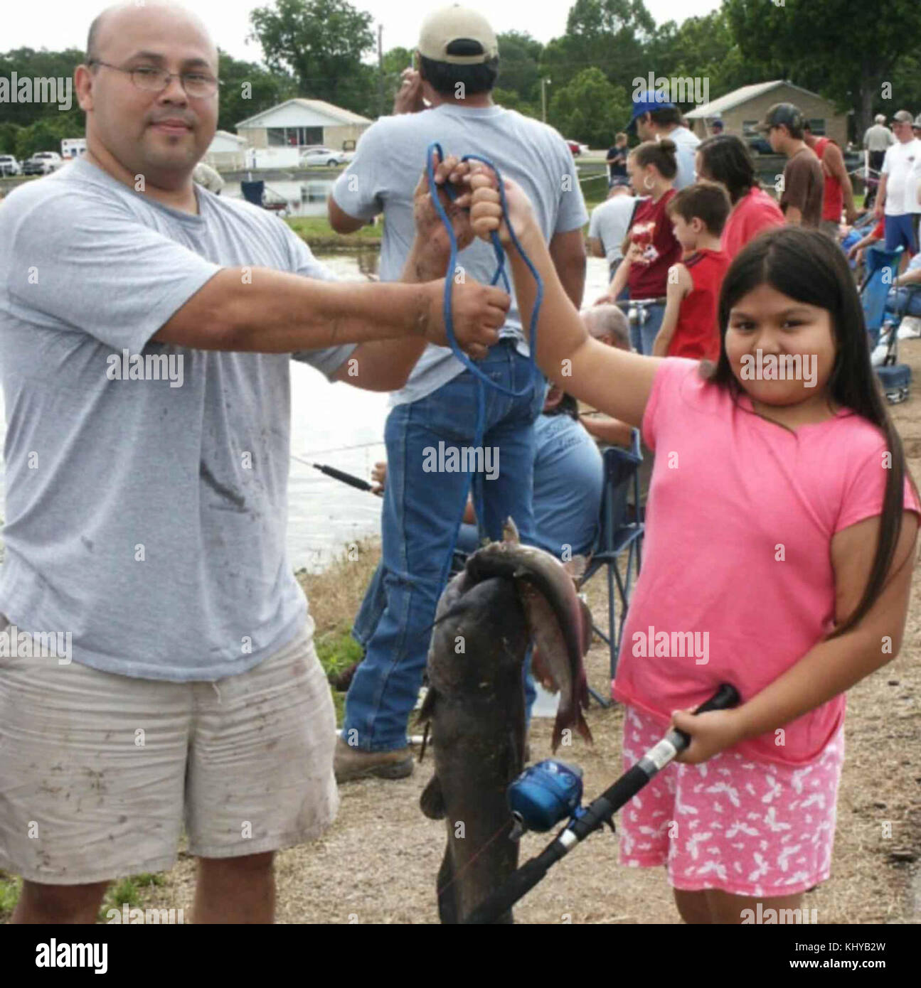 Father and daughter hold fish Stock Photo - Alamy