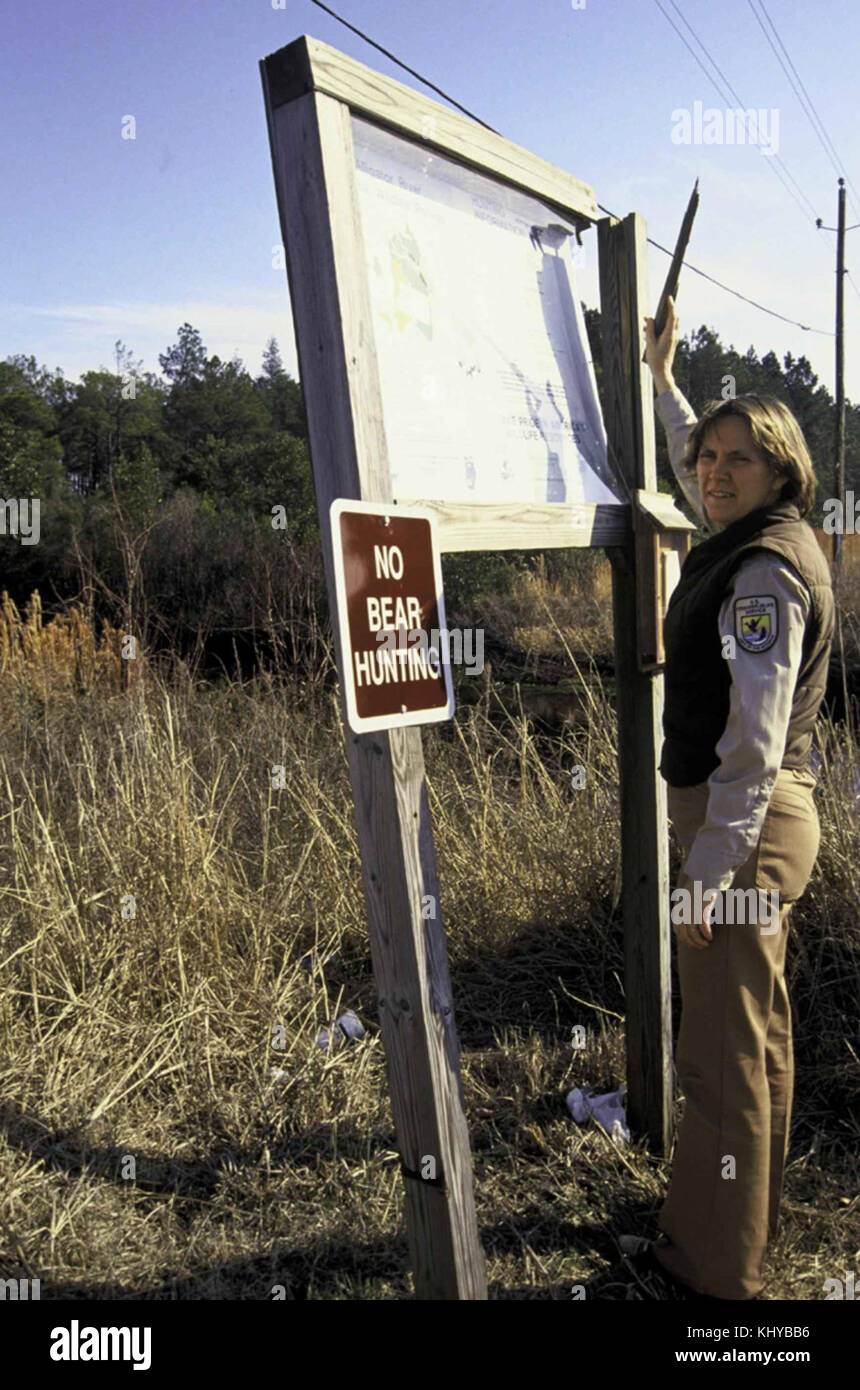 A female individual is pictured checking signs, possibly in a ...