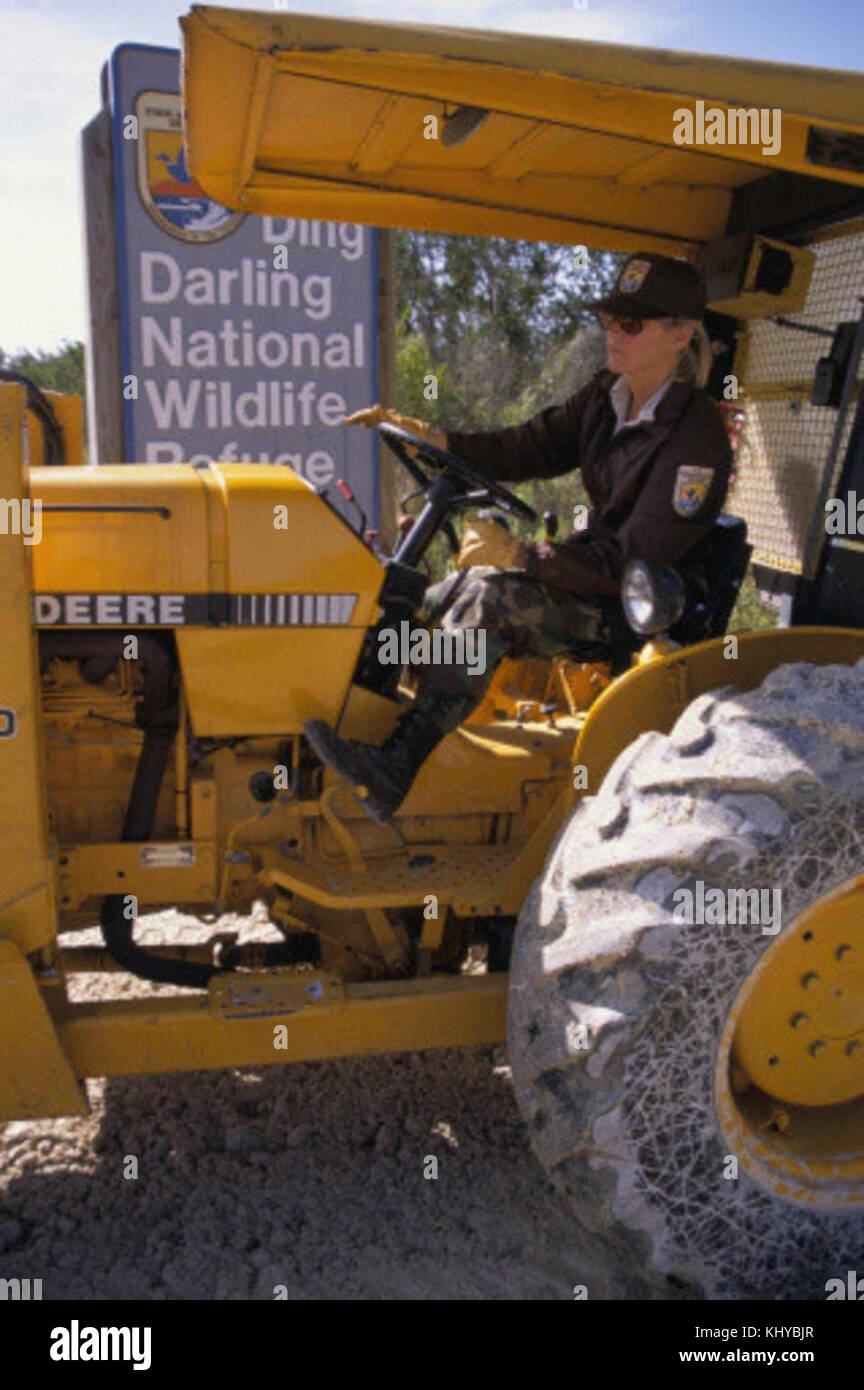 This image shows a female driver operating heavy machinery, likely on a ...