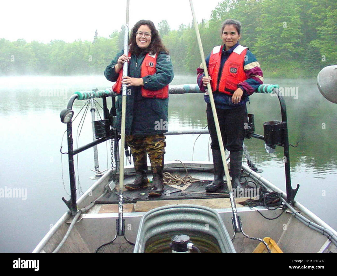 Females on boat stocking fish Stock Photo - Alamy