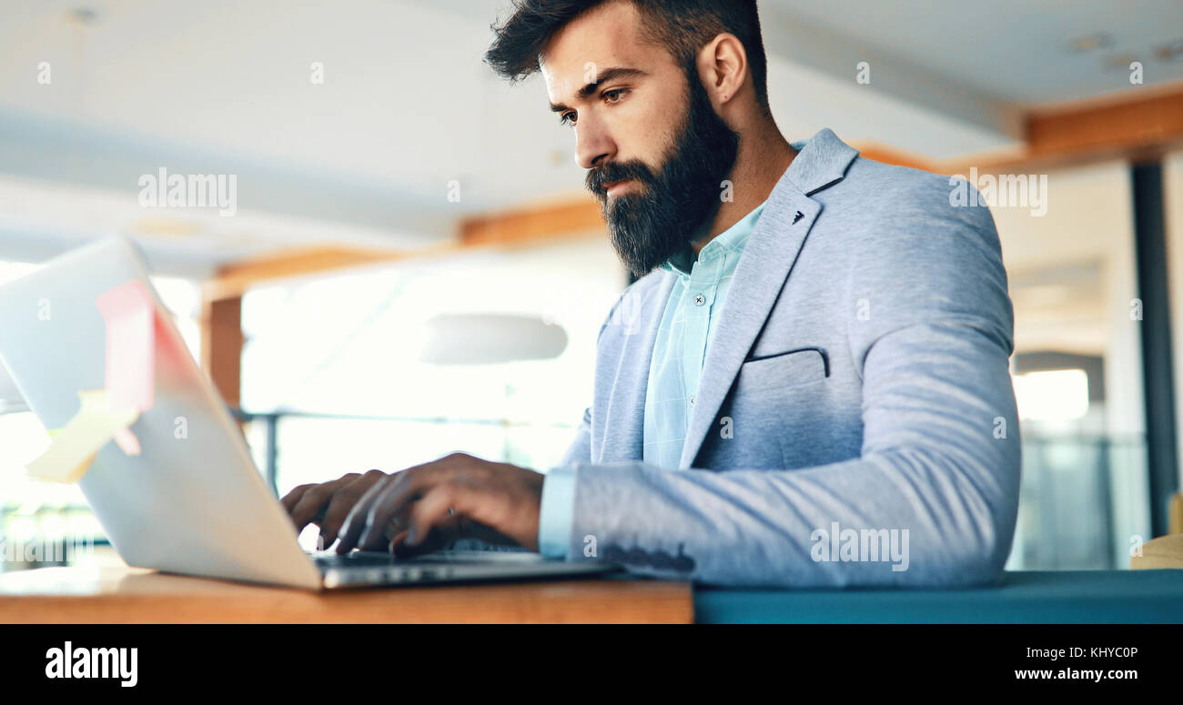 Businessman working on laptop Stock Photo - Alamy