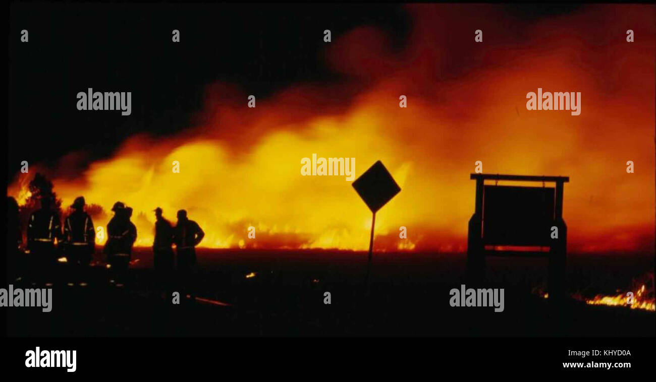 Firefighters in night fire Stock Photo - Alamy