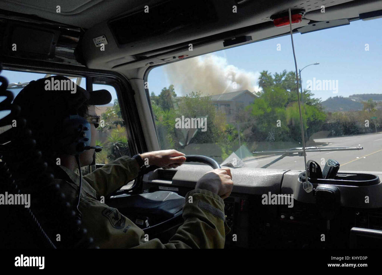 Firefighting crew in fire truck responding to fire Stock Photo - Alamy