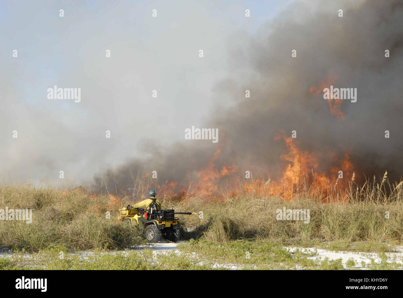 Fireman driving atv vehicle and starting fire Stock Photo - Alamy