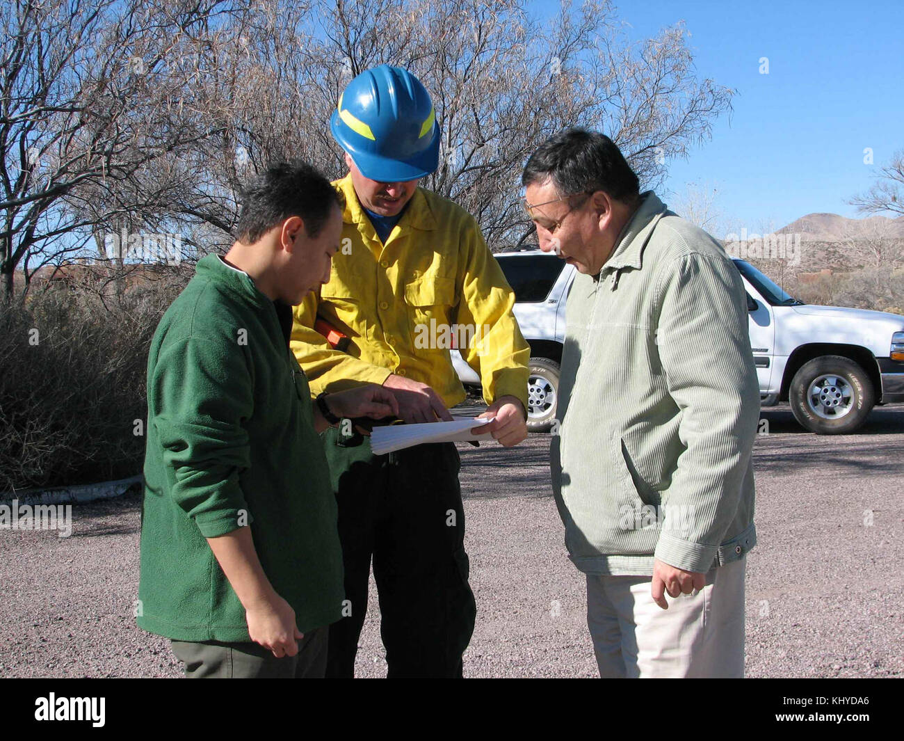 Fireman talks with two men Stock Photo - Alamy