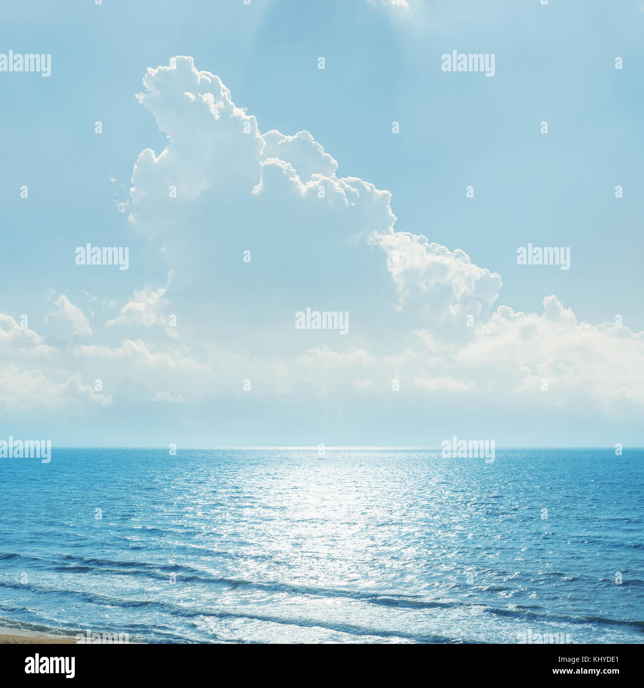clouds in blue sky over sea and reflections of sun Stock Photo - Alamy