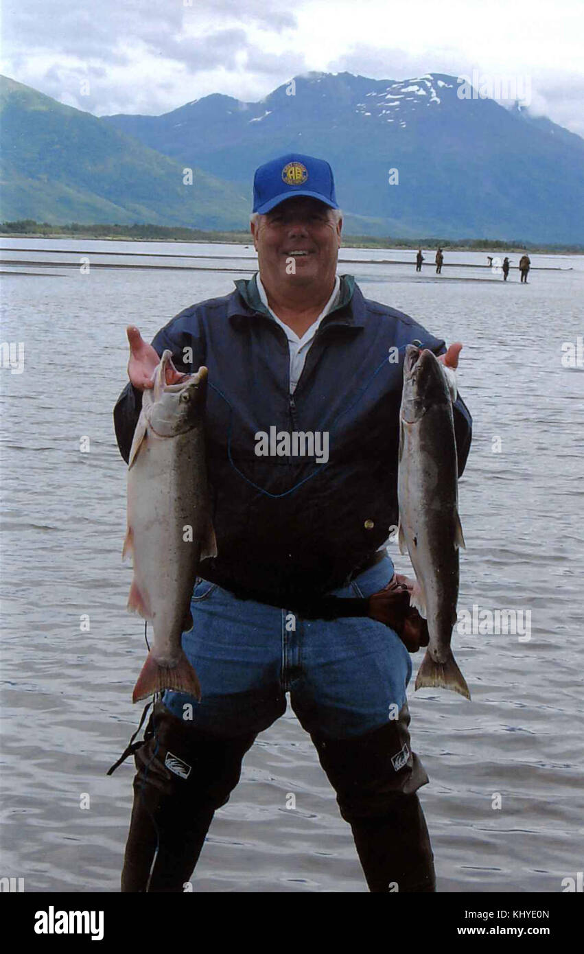 Fisherman holds fish silver coho salmon Stock Photo - Alamy