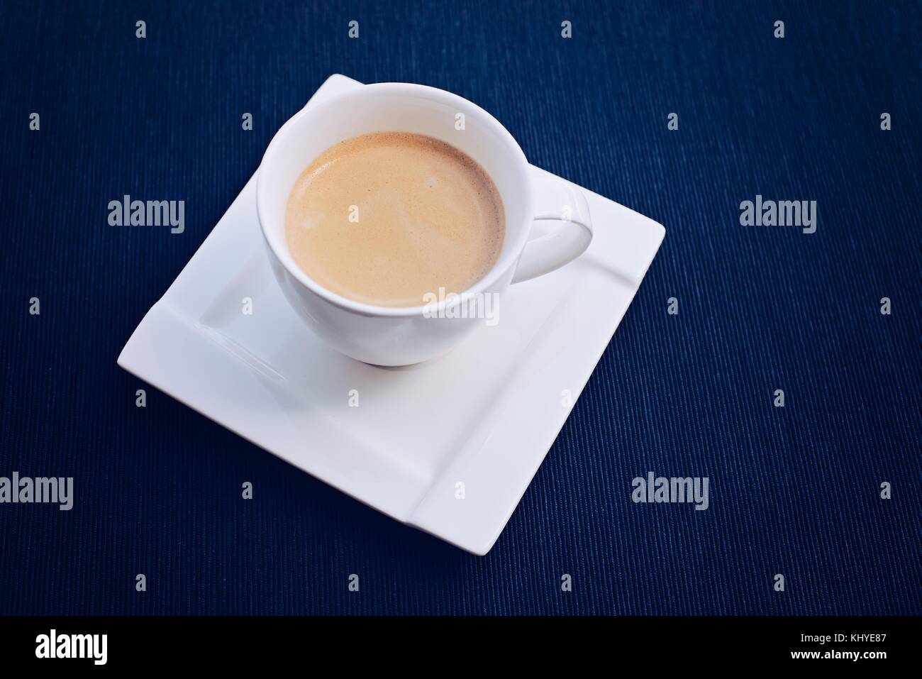 Freshly made coffee in a small white cup with saucer Stock Photo - Alamy