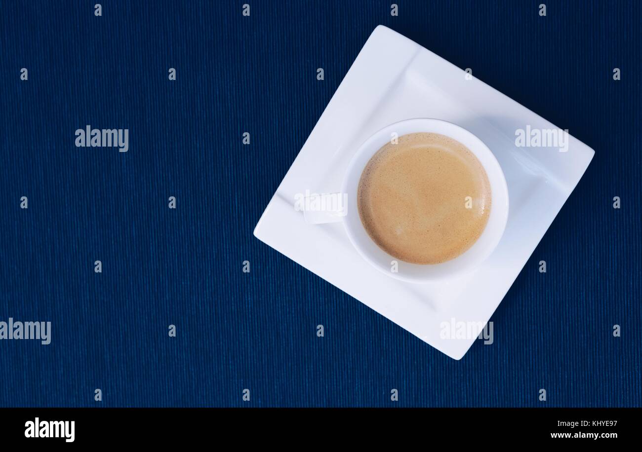 Freshly made coffee in a small white cup with saucer Stock Photo - Alamy