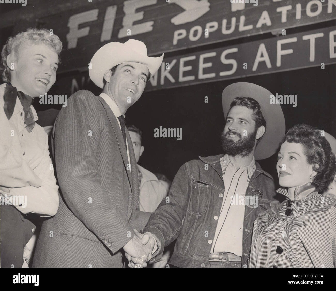 Handshake at Frontier Fiesta sign Stock Photo - Alamy