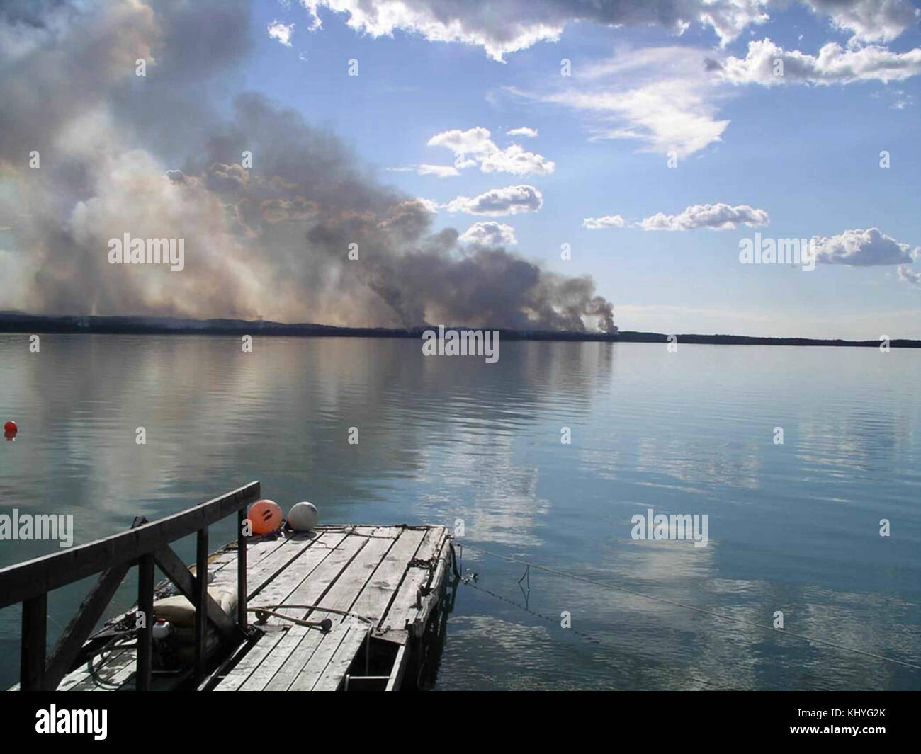 Forest fire burn as seen from lake dock Stock Photo - Alamy