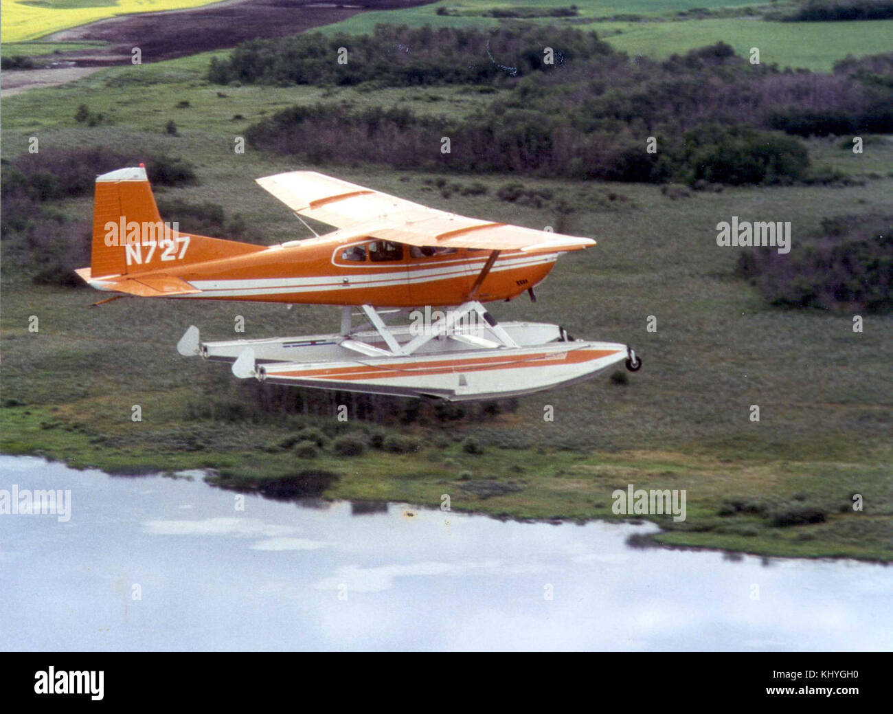 This image captures an aircraft flying over a body of water, possibly ...